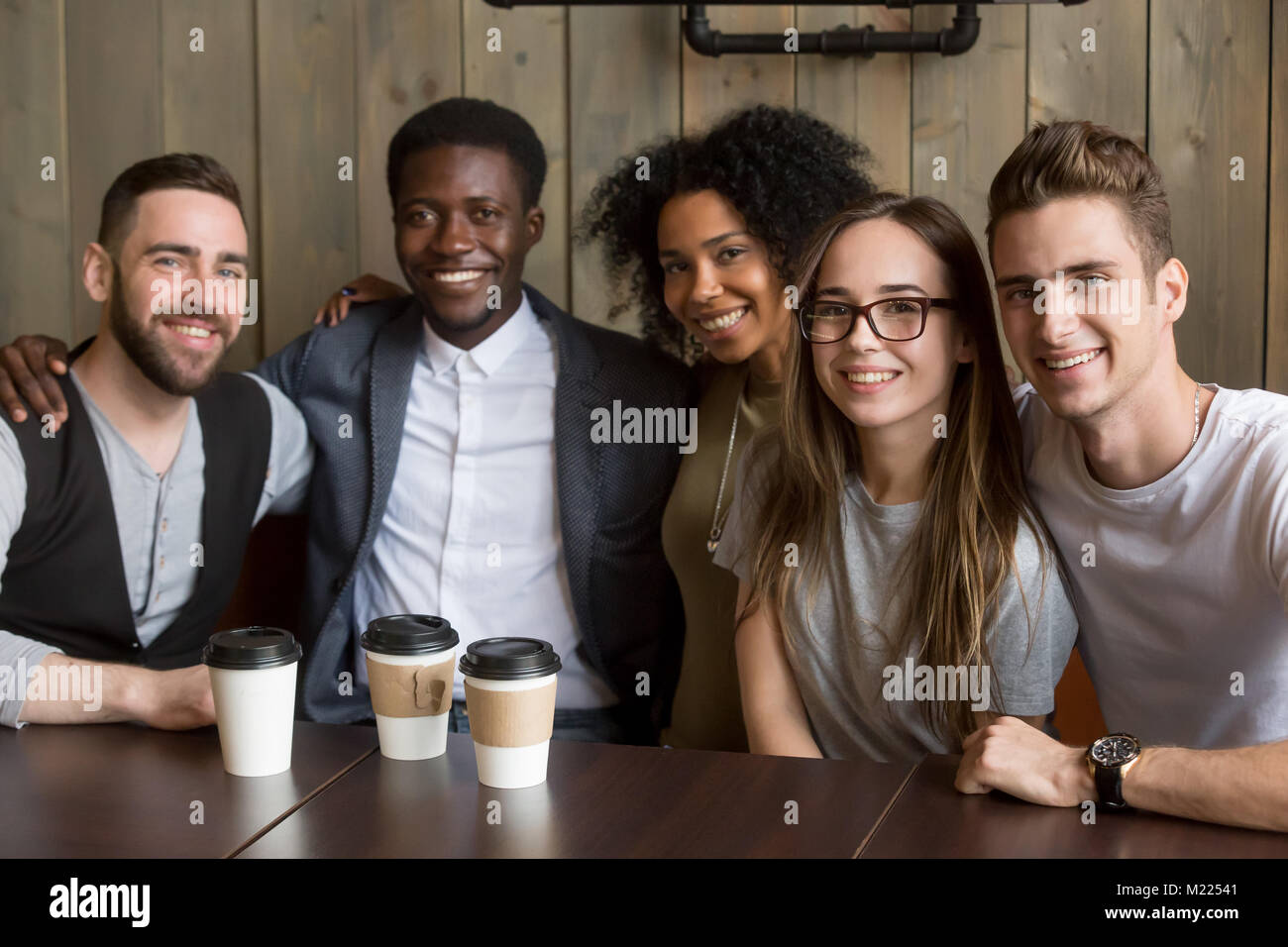 Multicultural millennial young friends looking at camera in cafe Stock ...