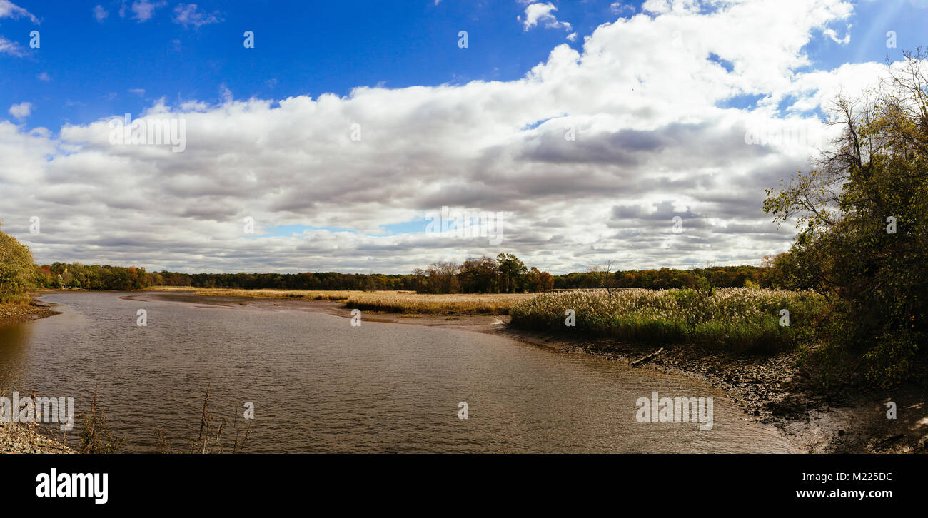autumn landscape of river and trees without leaves blue sky and clouds ...