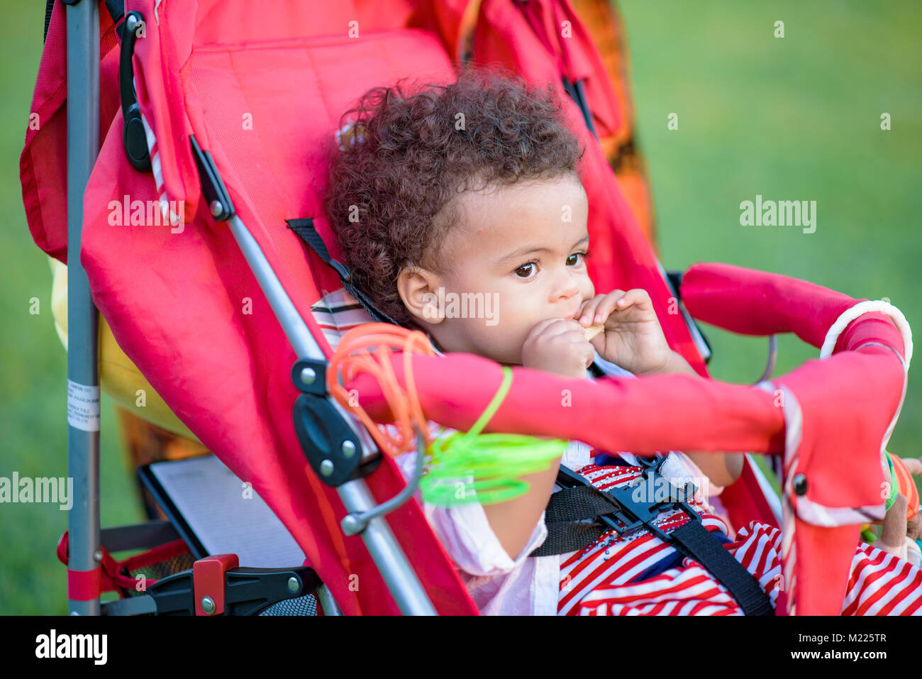 Cute little baby girl in a stroller Stock Photo - Alamy