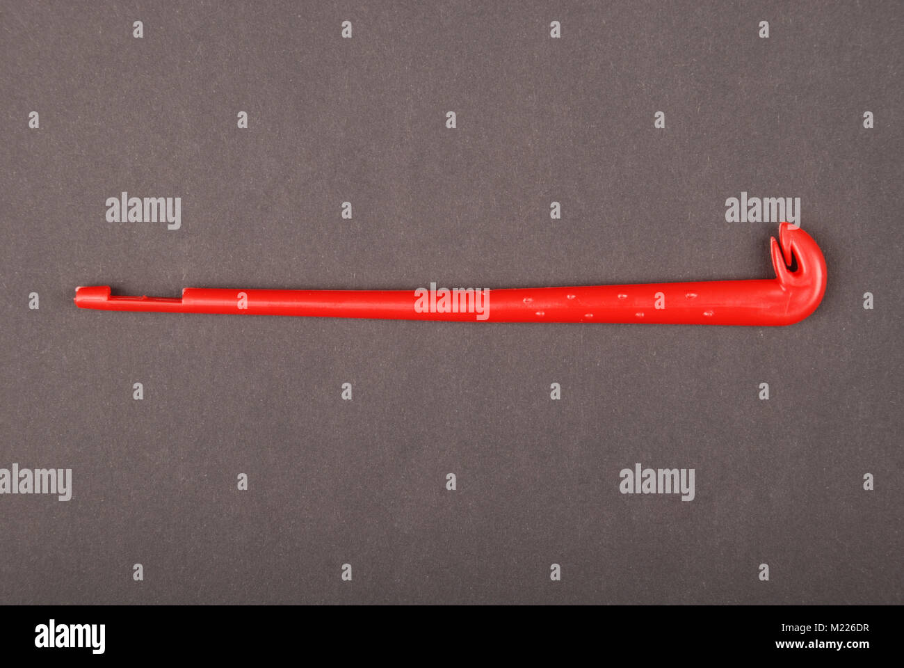 One red loop tier isolated on black background Stock Photo - Alamy