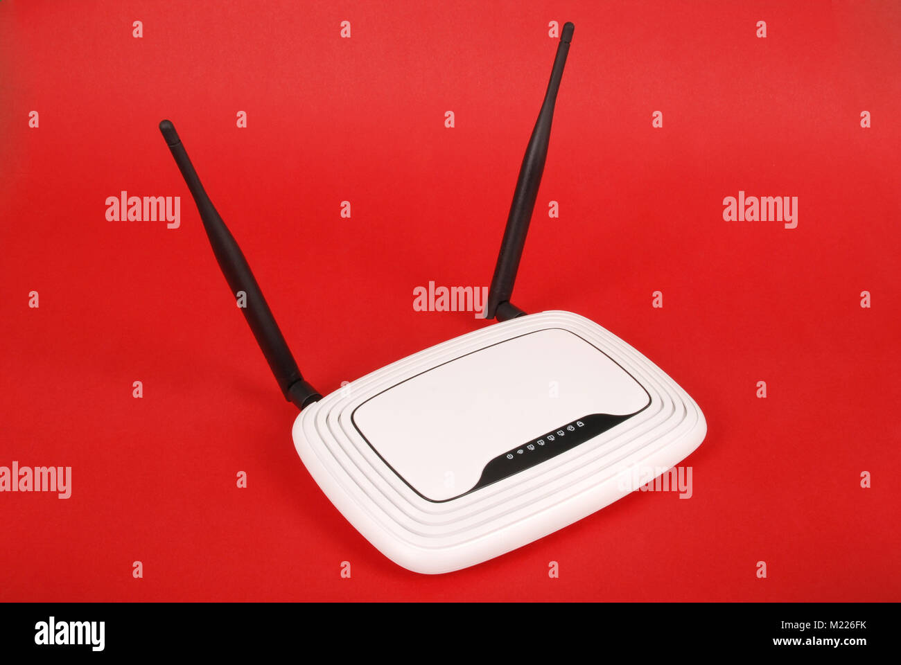 White WI-FI router with two antennas isolated on red background Stock ...