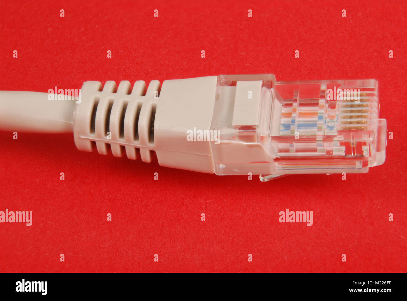 Lan cable and connector RJ45, isolated on red background Stock Photo ...