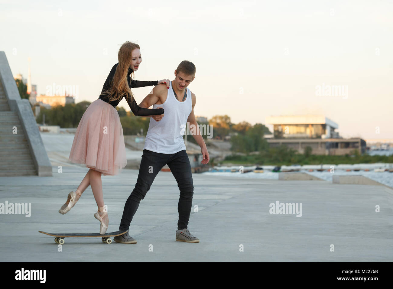 Young Couple In Love On A Date A Guy Sportsman Teaches His Girlfriend