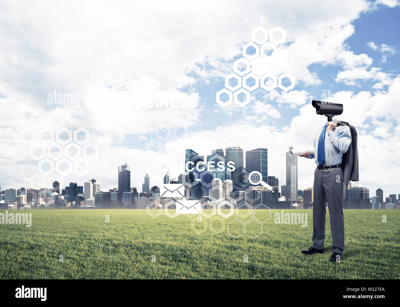 Camera headed man standing on green grass against modern citysca Stock ...