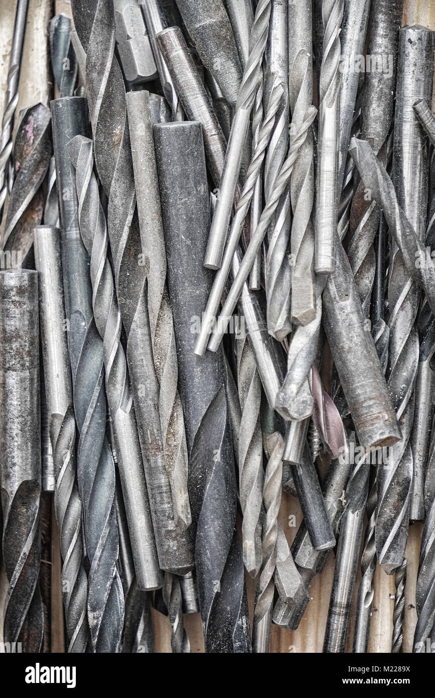 Old steel drill bit for drill on wooden background Stock Photo - Alamy