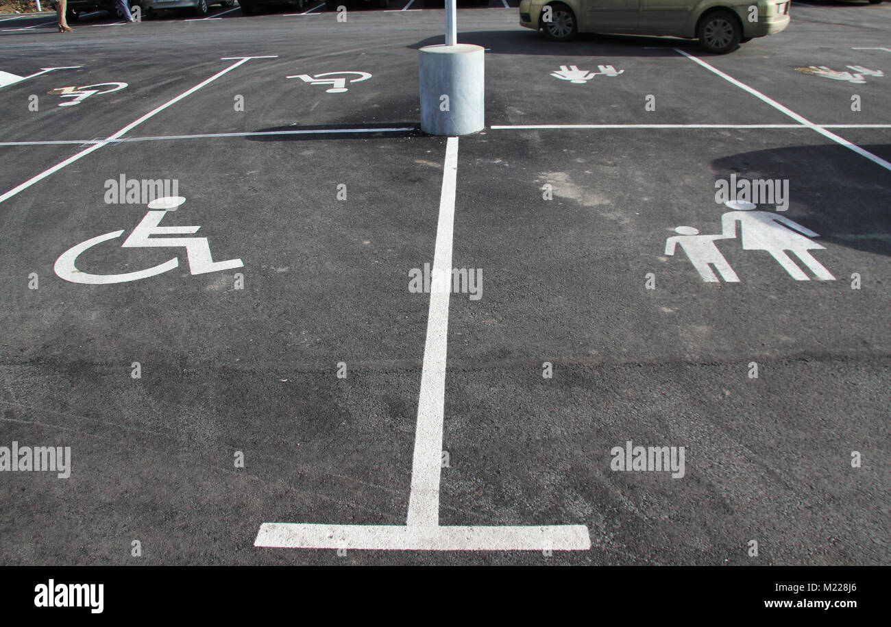 "Handicap” and “Mother with child” icons. Parking signs. Parking lot ...