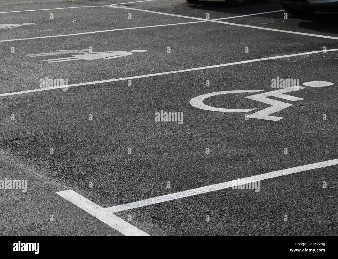 "Handicap” and “Mother with child” icons. Parking signs. Parking lot ...