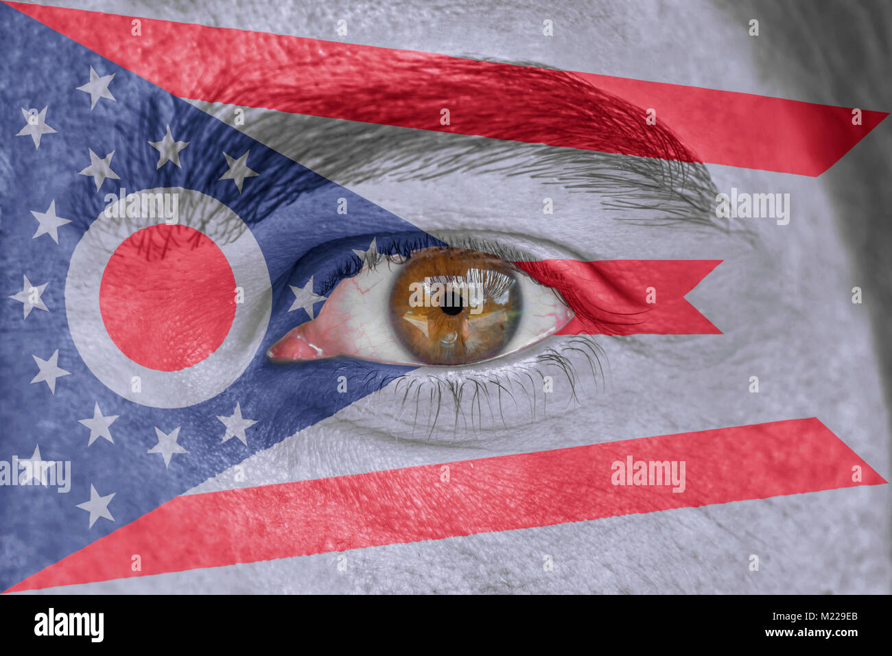Human face and eye painted with US state flag of Ohio Stock Photo - Alamy