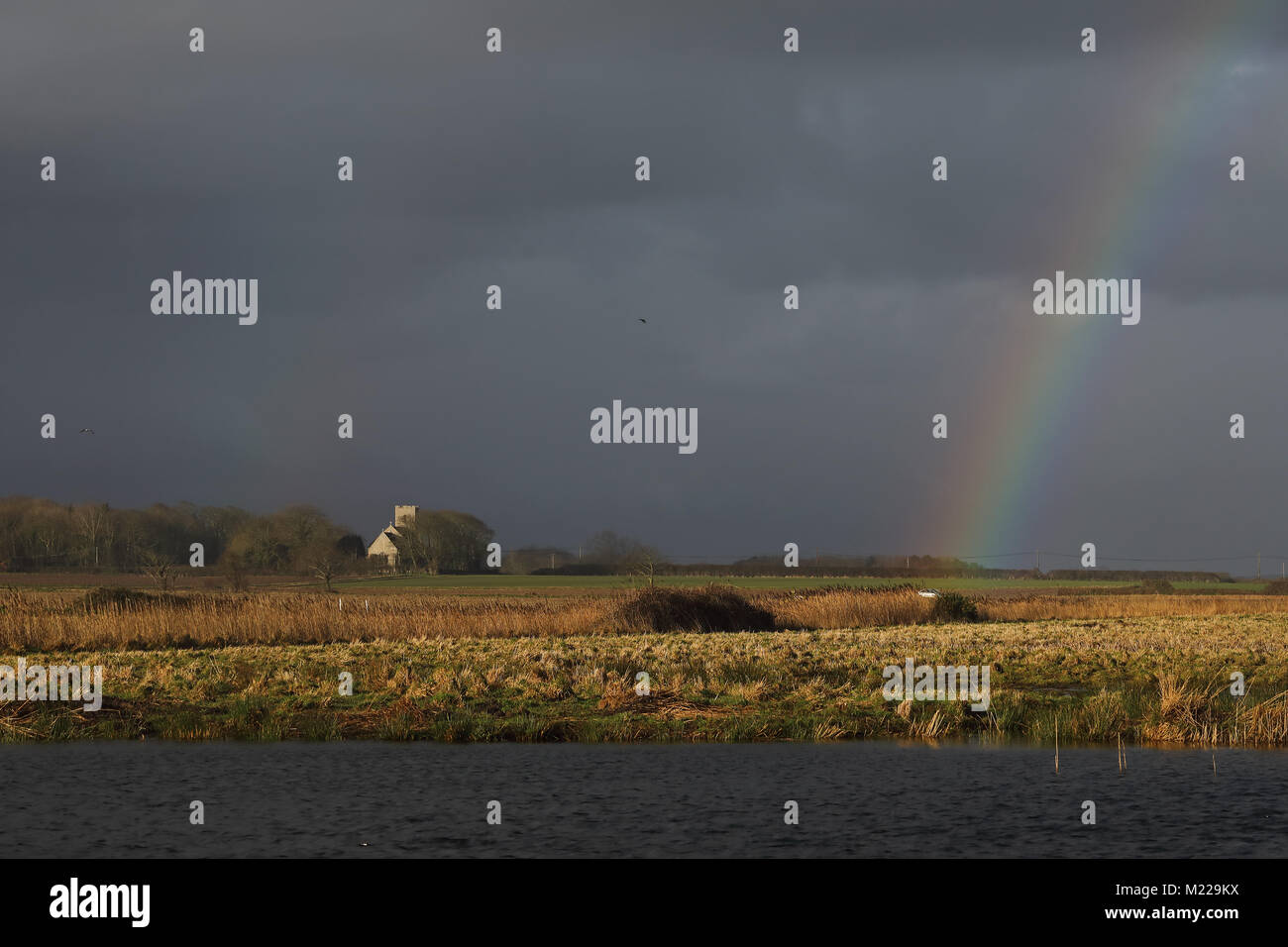 stormy sky with rainbow over marshes Hempstead marsh, Lessingham ...