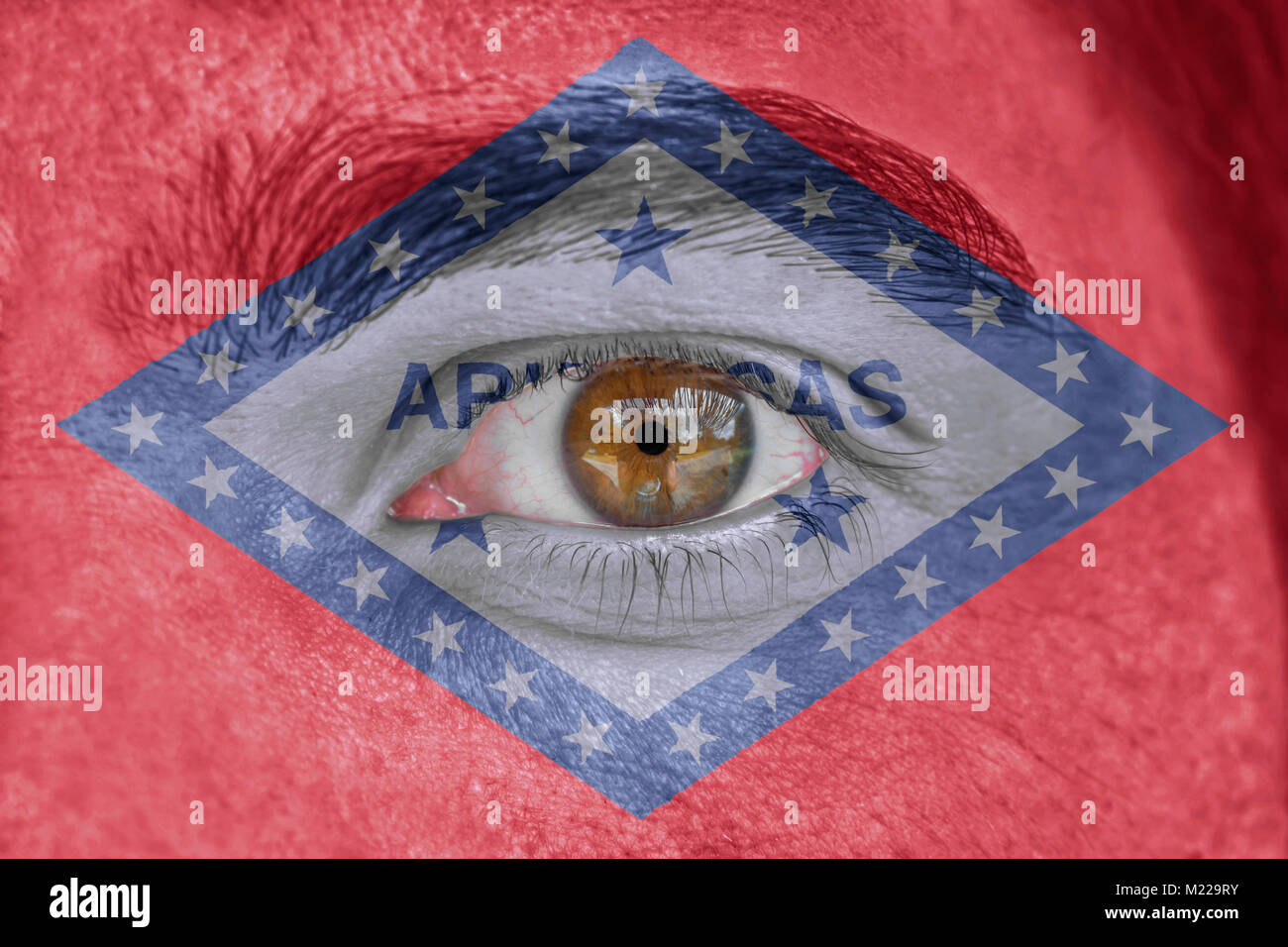 Human face and eye painted with US state flag of Arkansas Stock Photo ...