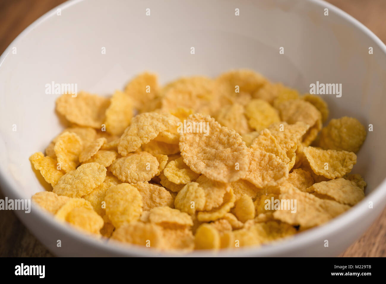 corn flakes in white bowl closeup Stock Photo - Alamy
