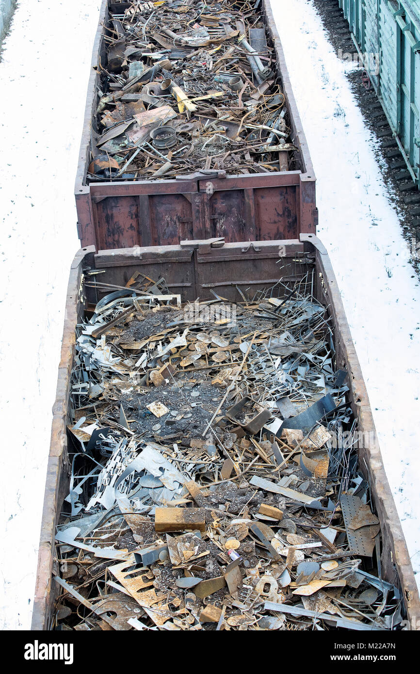 Railway wagon in winter filled with metal scrap. Old rusty corroded ...