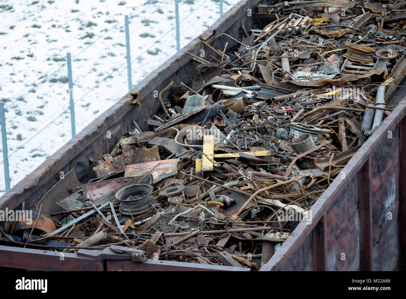 Railway wagon in winter filled with metal scrap. Old rusty corroded ...