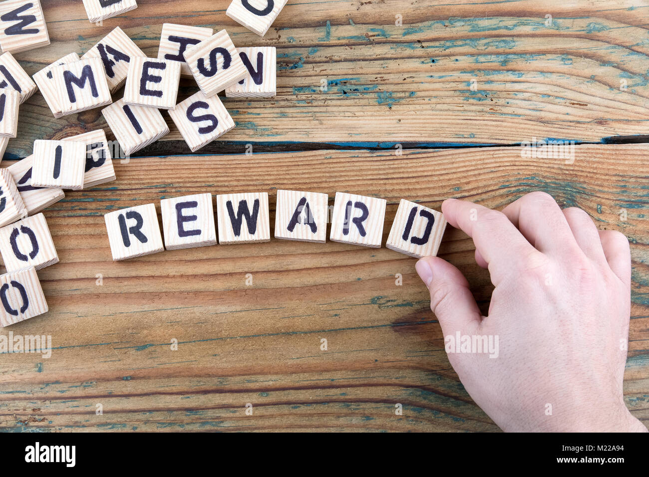 reward. Wooden letters on the office desk, informative and ...