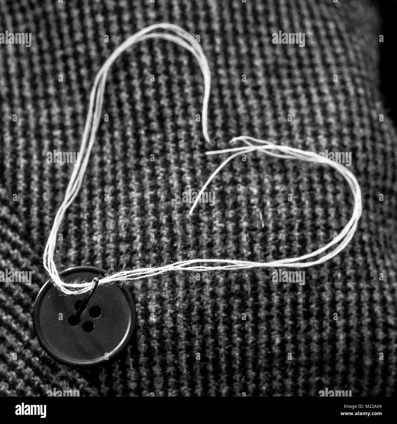 Sowing a button on a coat hi-res stock photography and images - Alamy