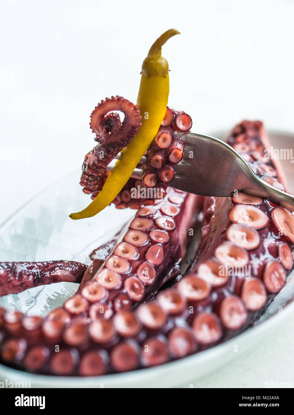 A snack made from octapus and green spicy pepper ona top of whole ...