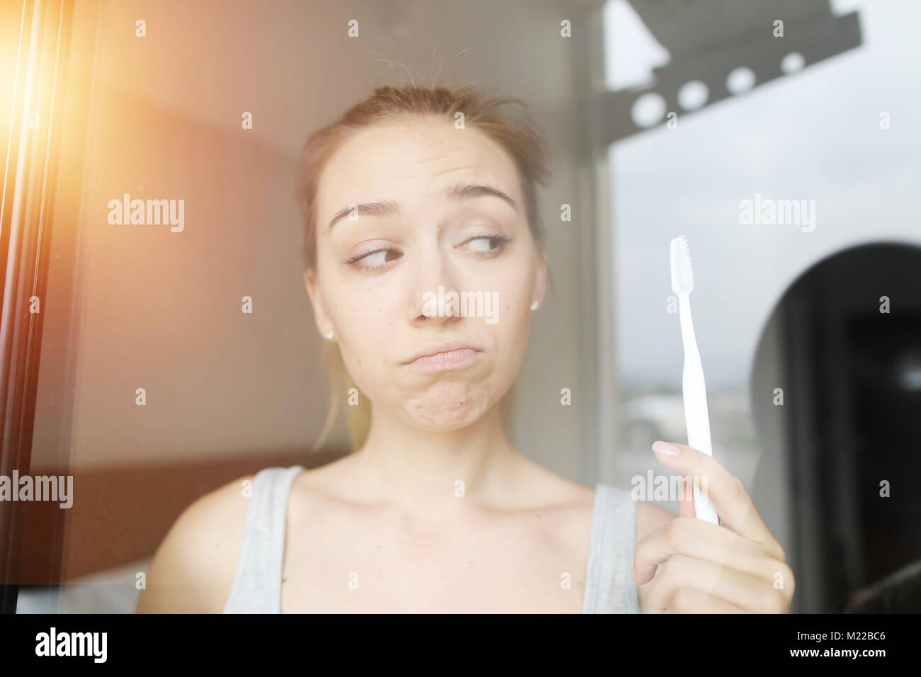 young upset woman with toothbrush looking sad Stock Photo - Alamy