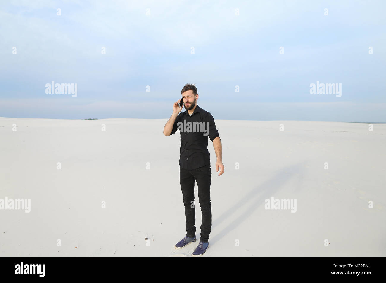 Amateur photographer guy speaking on smartphone at seaside Stock Photo ...