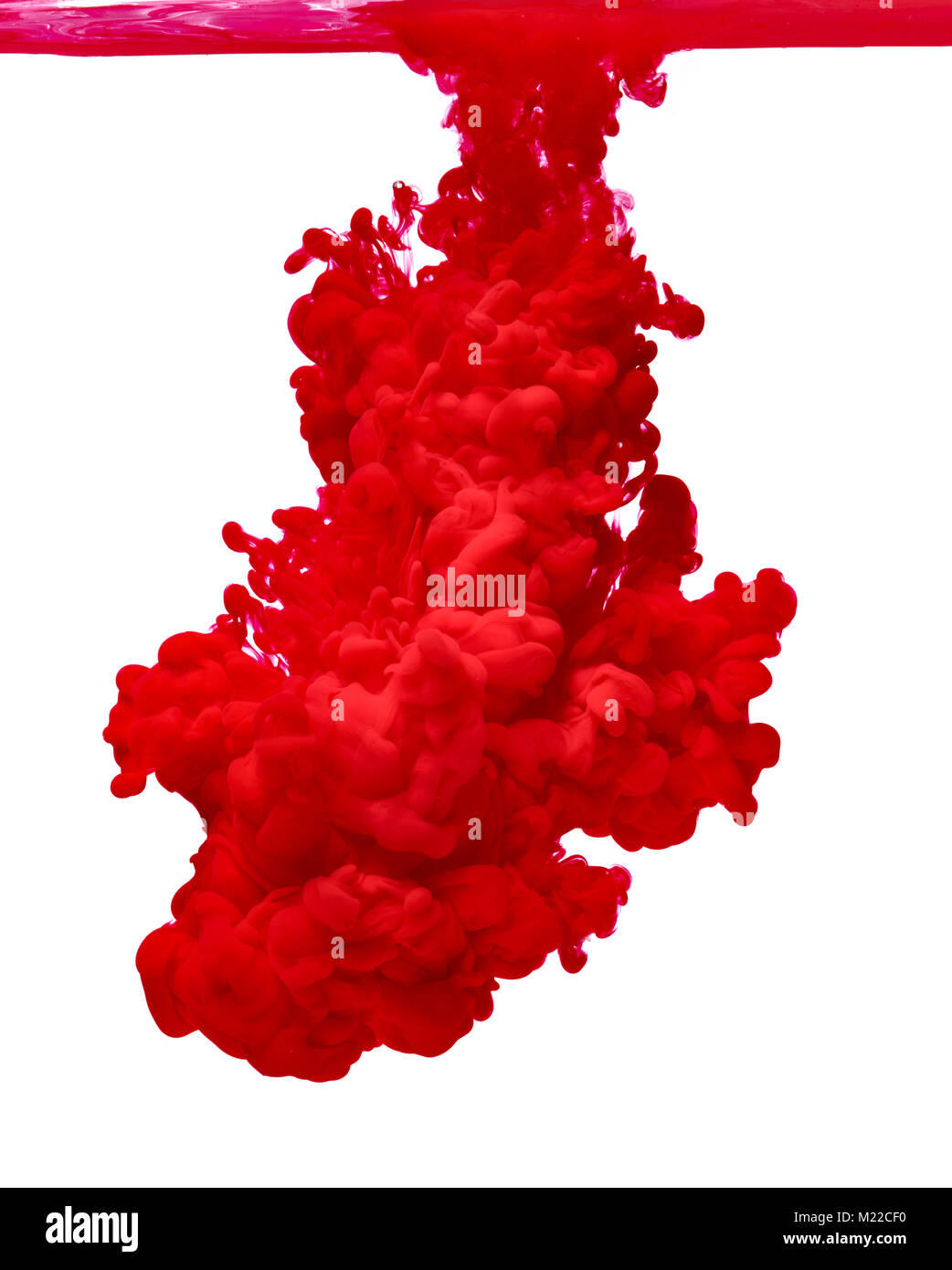 red color paint pouring in water Stock Photo - Alamy