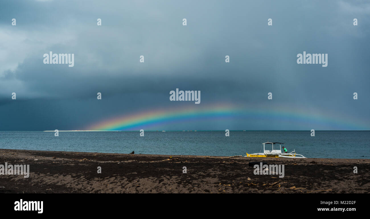 Rainbow dropping on White Island, Camiguin, Philippines Stock Photo - Alamy