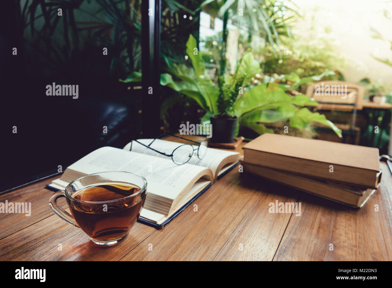 A cup of tea with books on table Stock Photo - Alamy