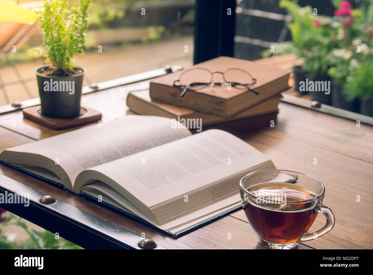 A cup of tea with books on table Stock Photo - Alamy