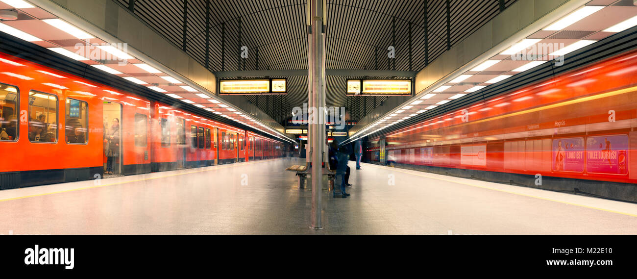 Two subway trains in an underground station at a nearly deserted subway ...