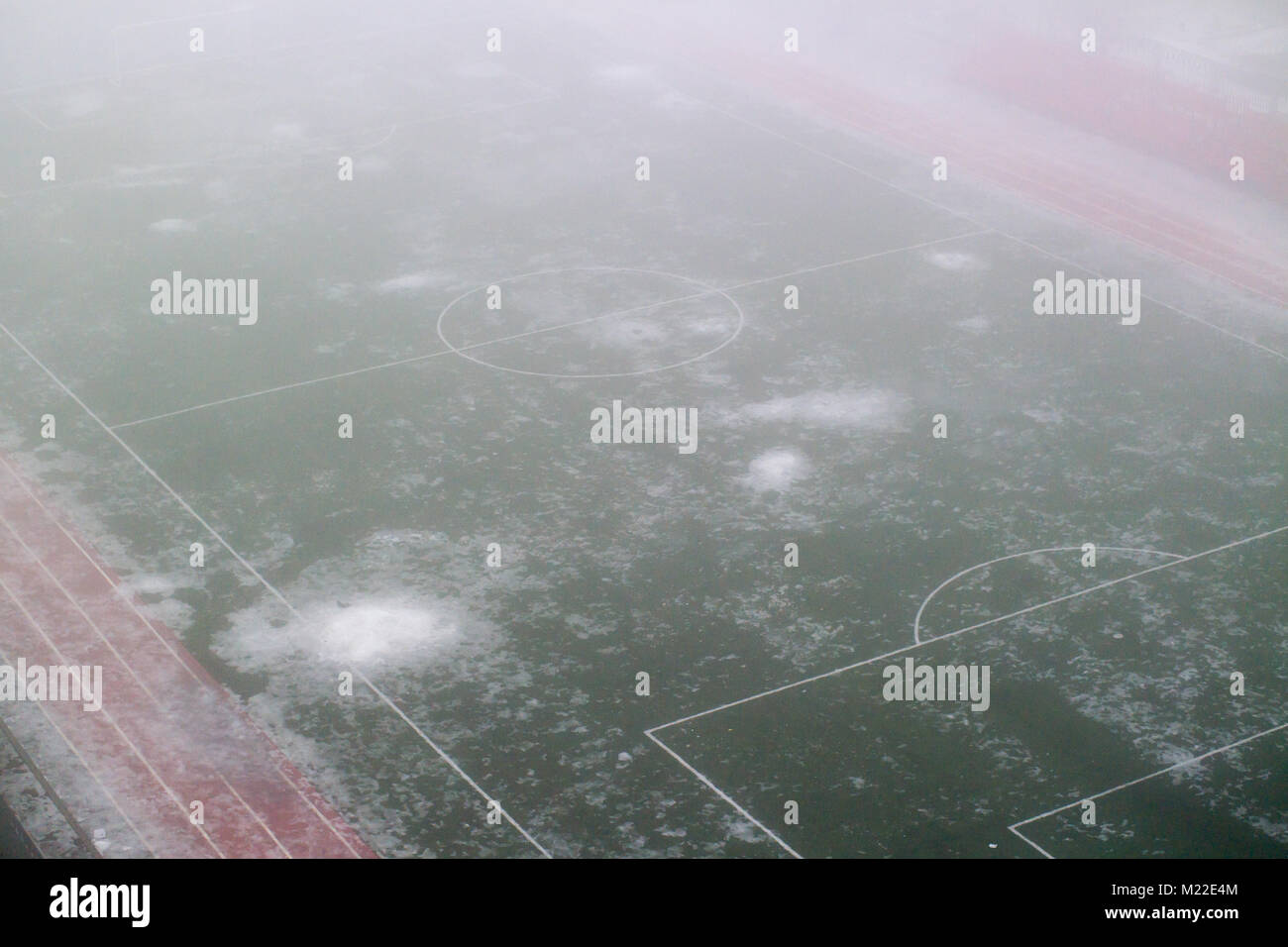 Football field in the fog and melting snow Stock Photo - Alamy