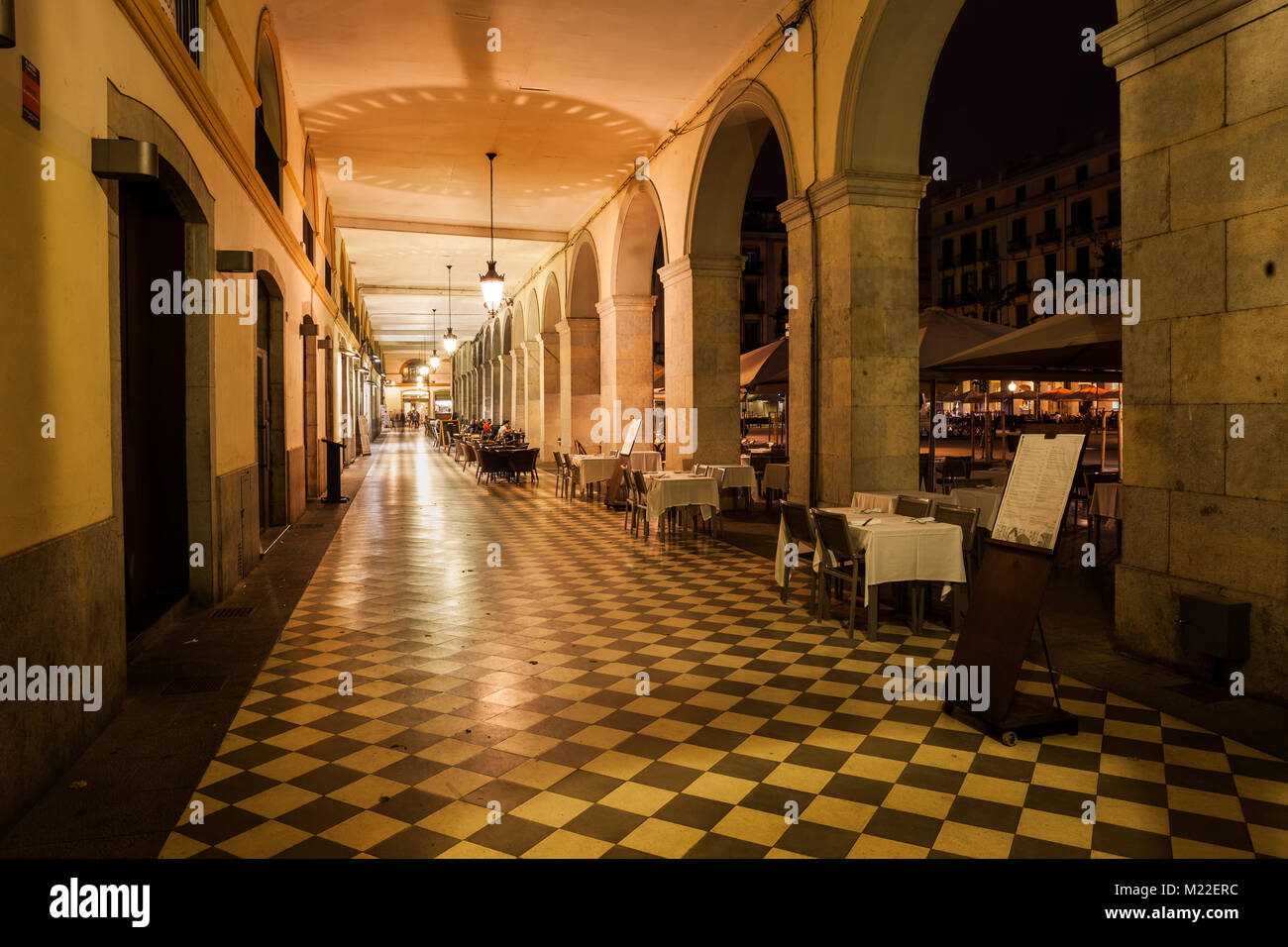 Arcade in Girona city by night, large covered walkway at Independence ...