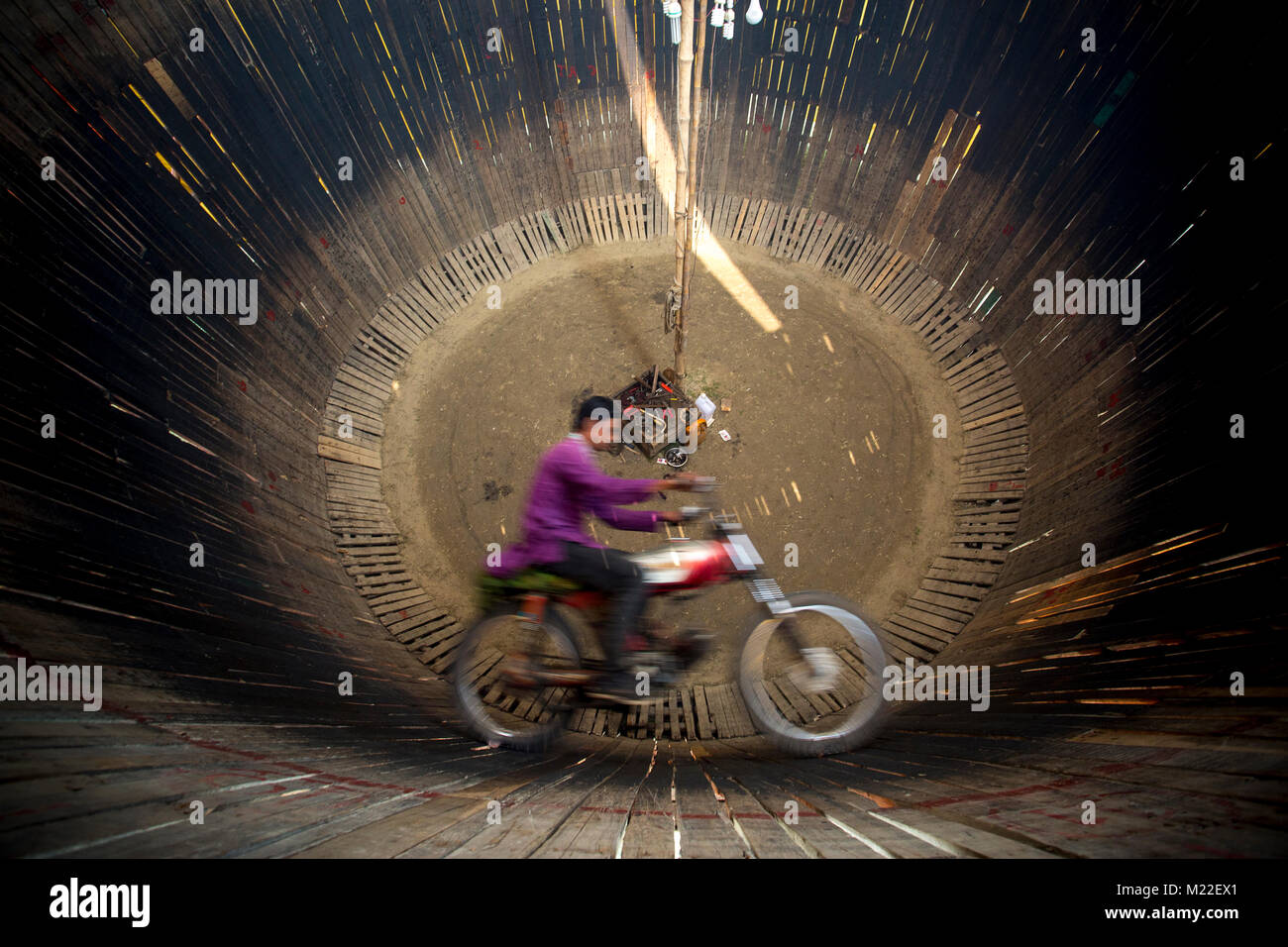 A dangerous motorbike carnival sideshow featuring a stunt biker takes ...