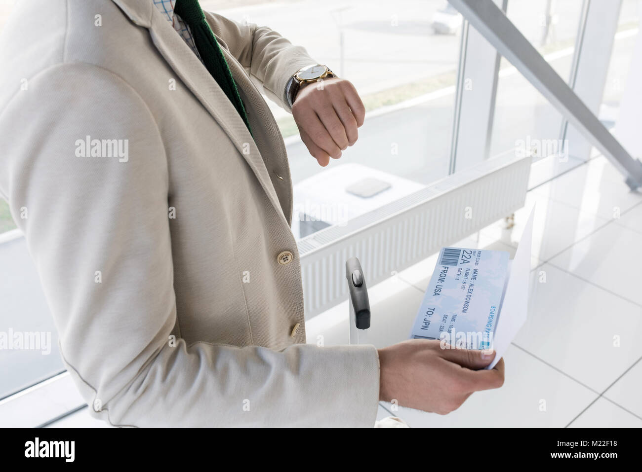 High angle view of unrecognizable businessman checking time and holding ...