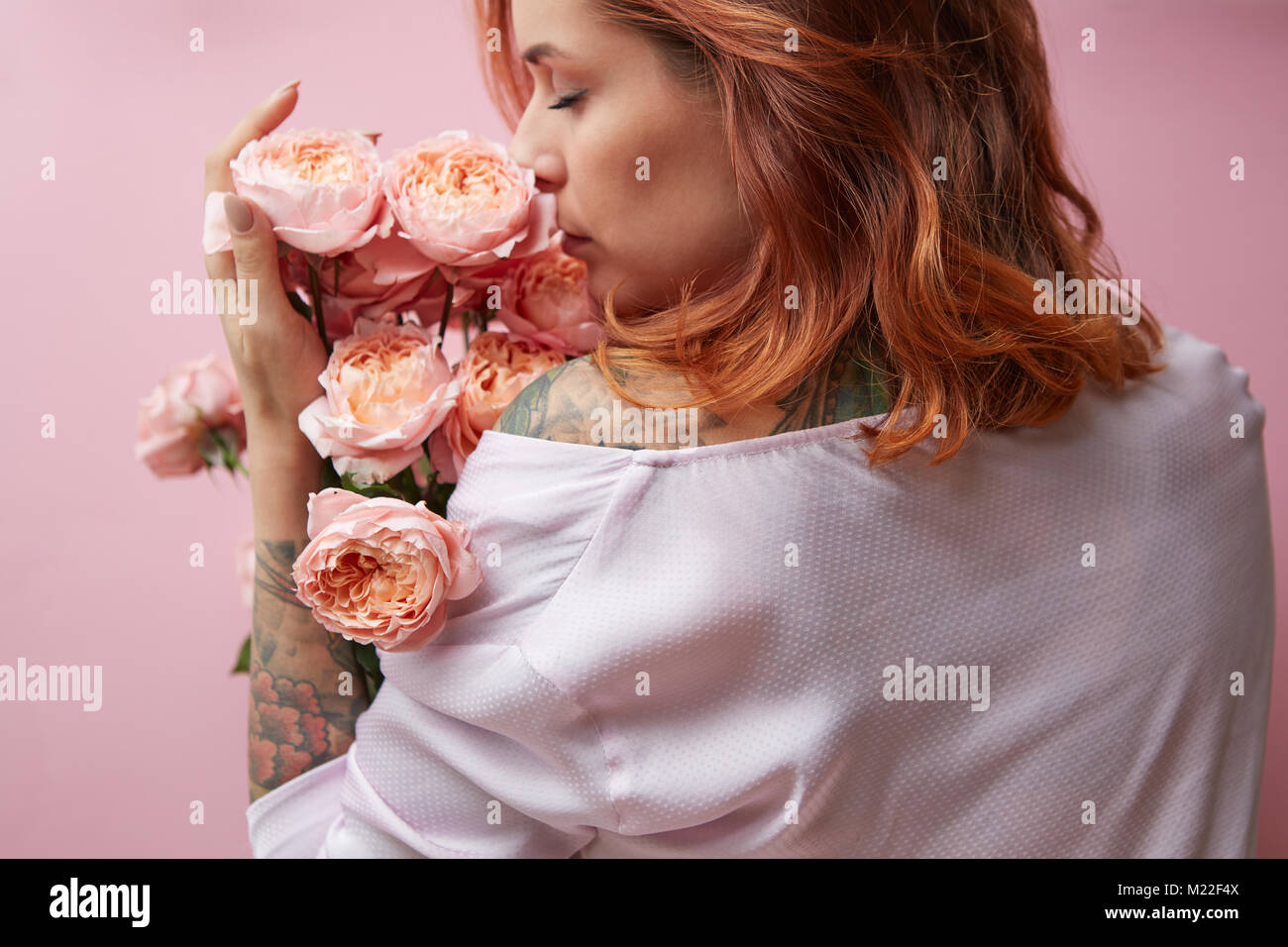 Woman sniffing rose hi-res stock photography and images - Alamy