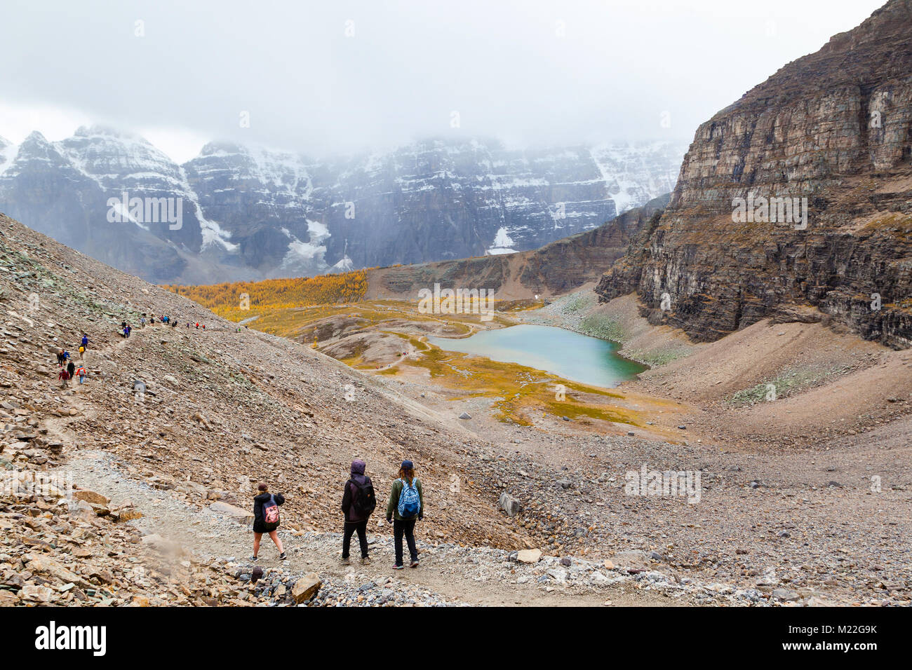 LAKE LOUISE, CANADA - SEPT 17, 2016: Hikers traverse the rocky trail at ...