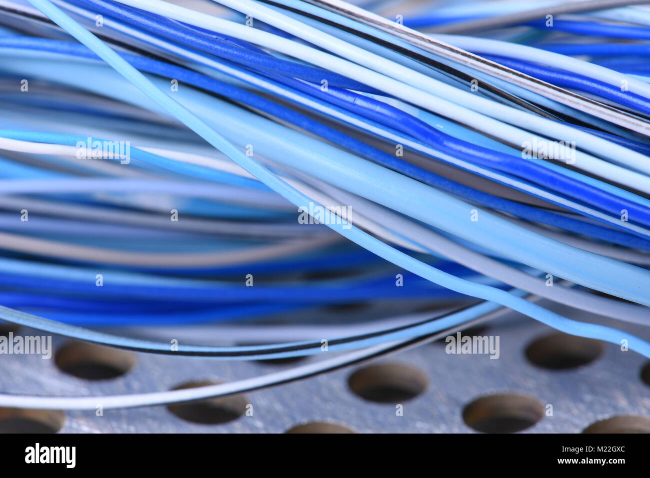 Electrical cables on metal background Stock Photo - Alamy