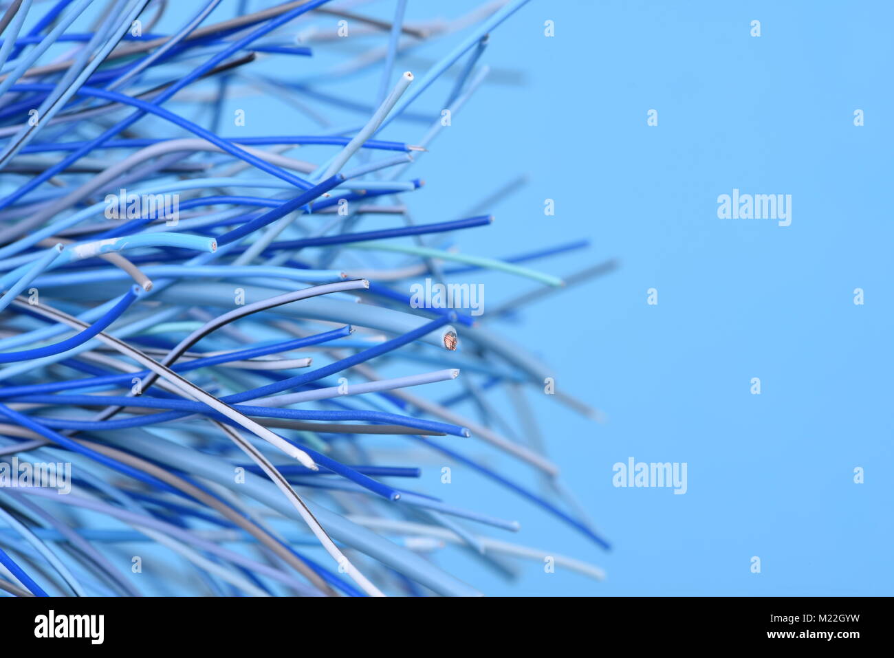 Electrical wire on blue background with place for text Stock Photo - Alamy