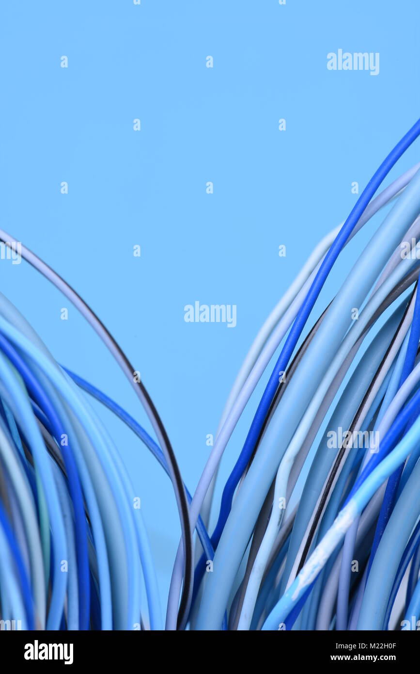 Electrical wire on blue background Stock Photo - Alamy