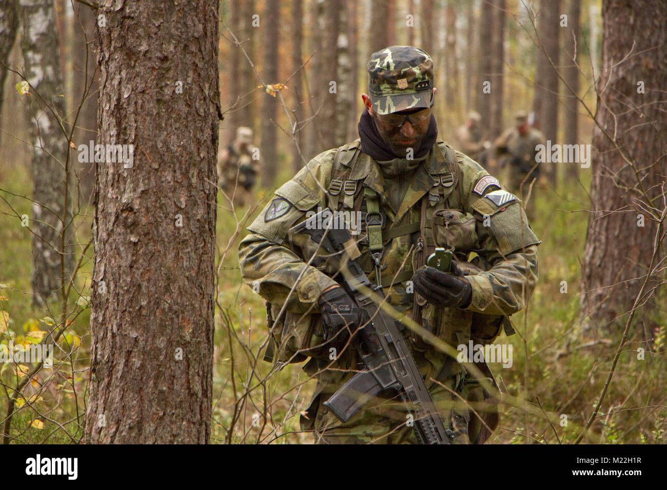 A soldier from 7th Mechanized Brigade, Czech Land Forces uses a compass ...
