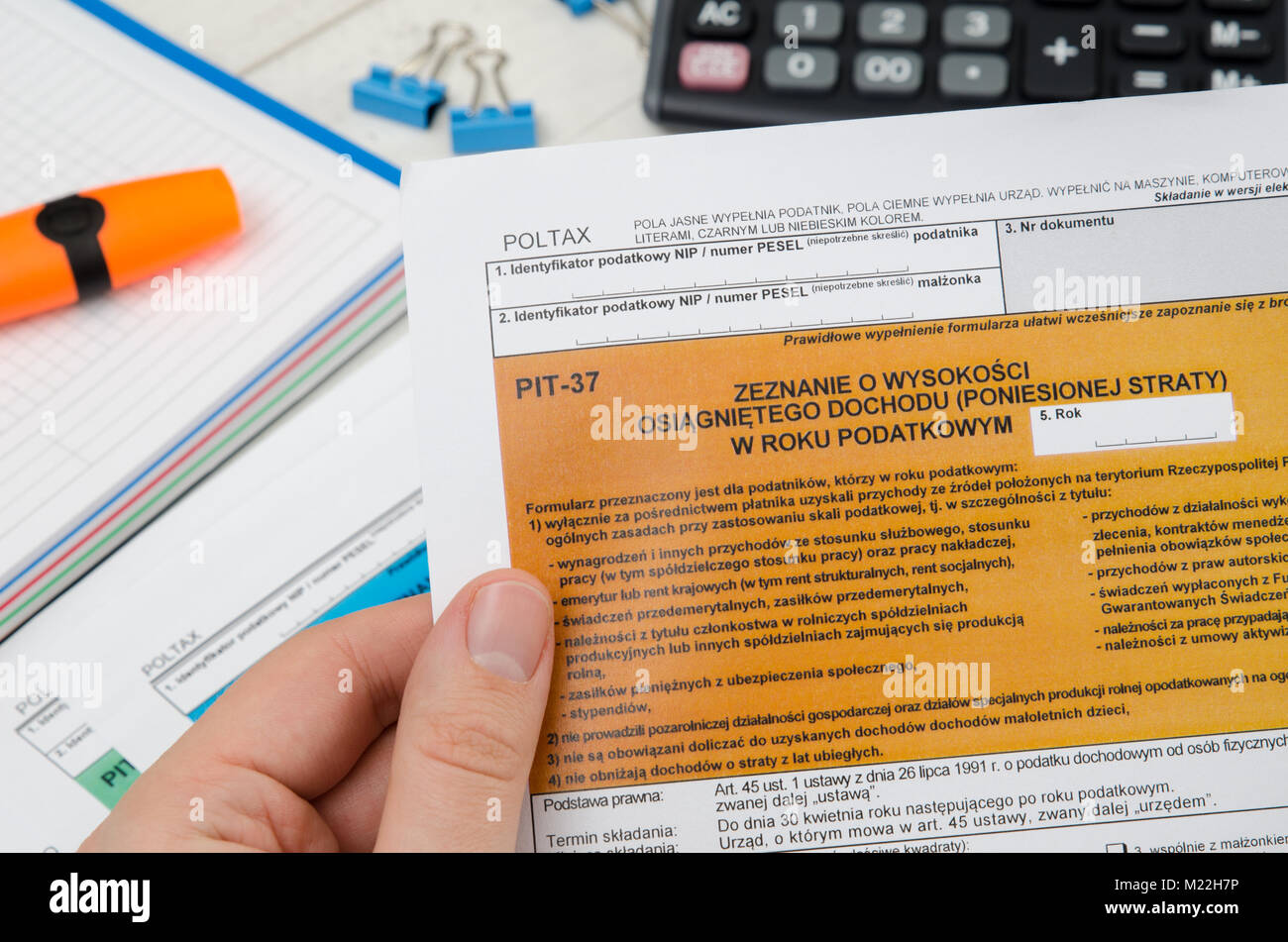 Man holding polish tax form PIT-37. Tax form law document poland ...