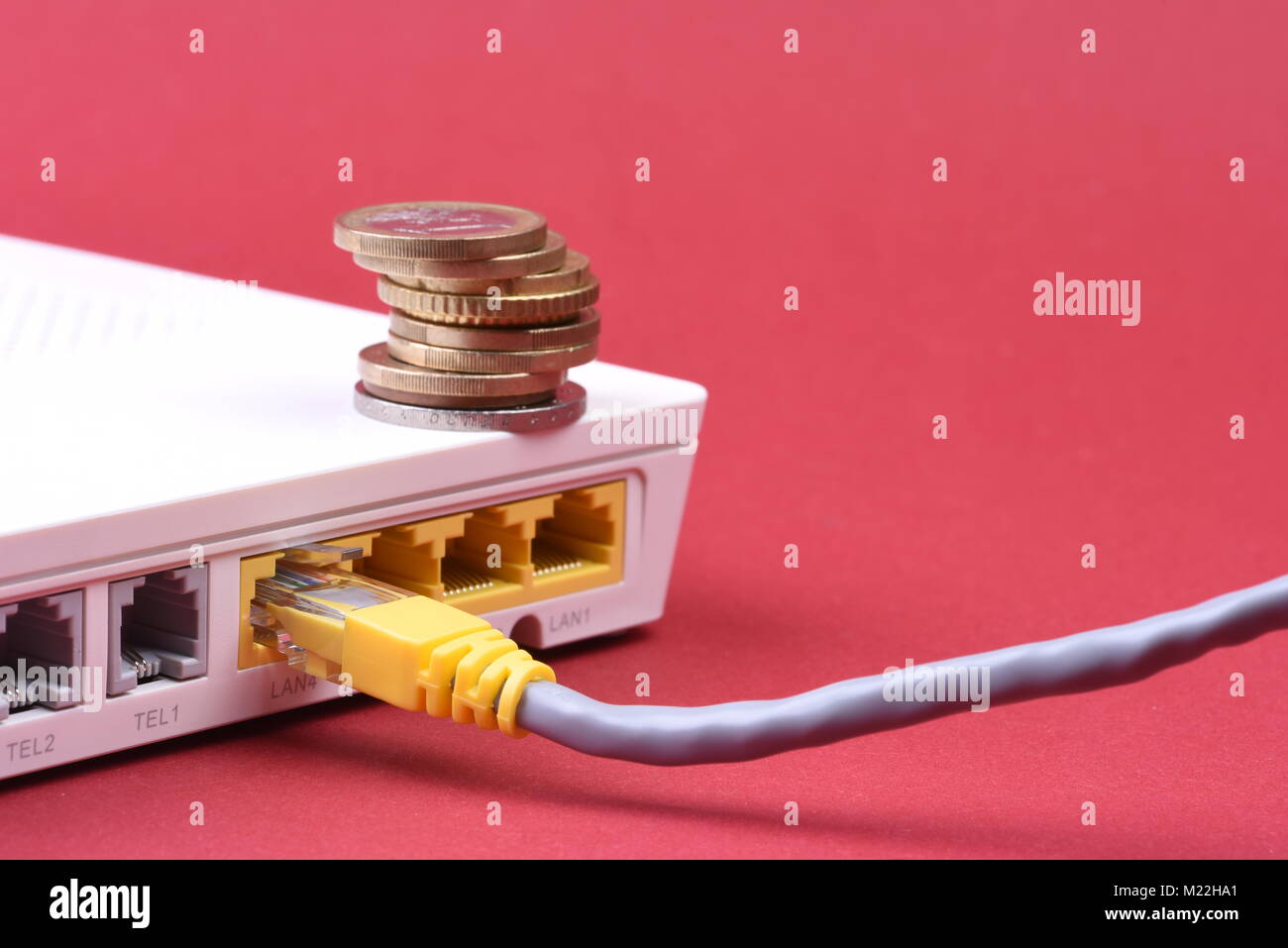 Coins and network router, paid access to the network Stock Photo - Alamy