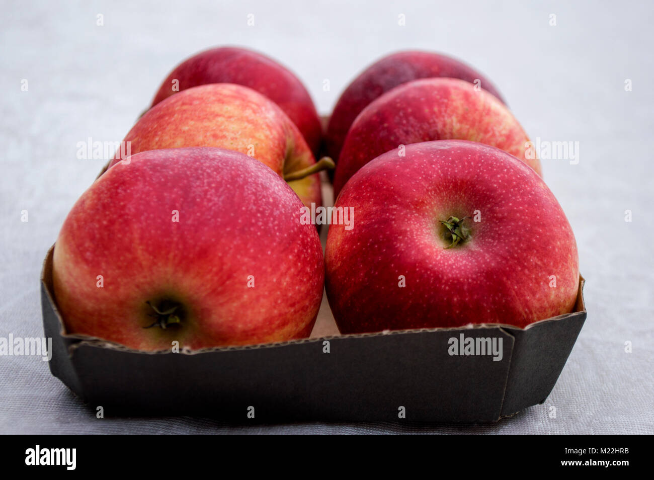 Box filled with fresh organic red apples on white background Stock ...