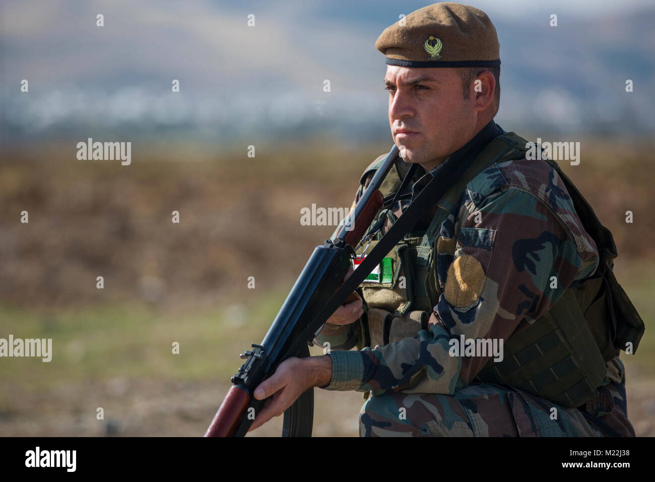 A coalition partner force member, with the security forces, scans his ...