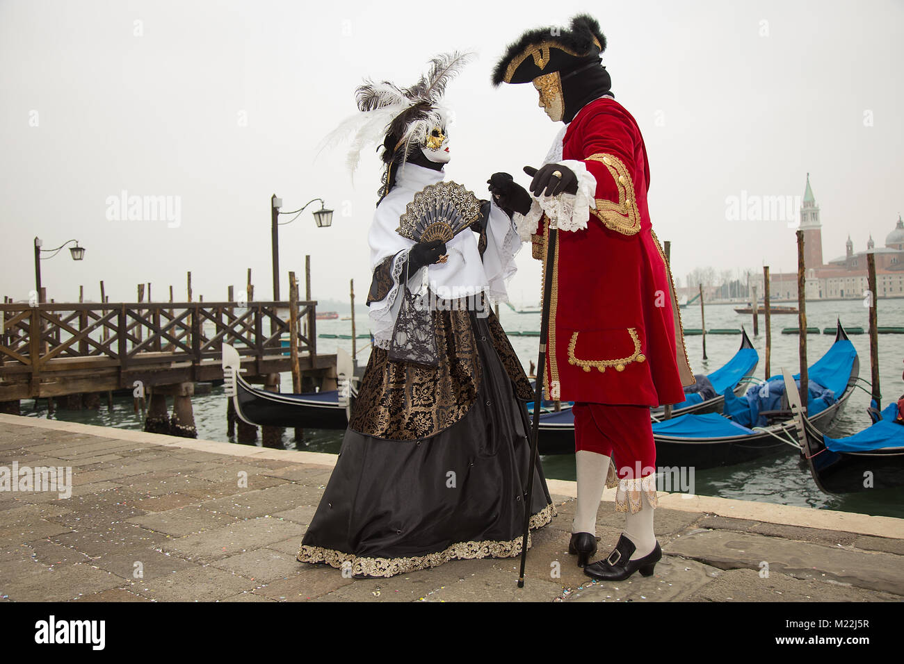 Venice Carnival - Couple in love of Venetian masks on St. Mark's Square ...