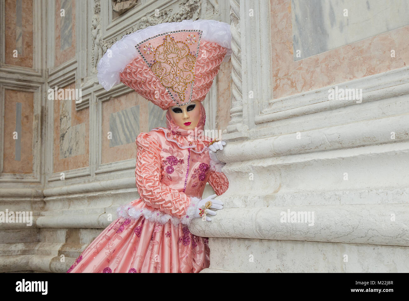 Female Venetian Mask in light pink elegant carnival costume at Venice ...