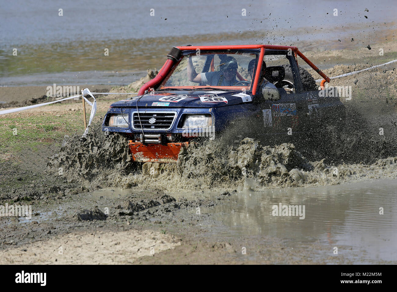 Offroad 4wd race - 4wd vehicle driving through mud and water in full ...