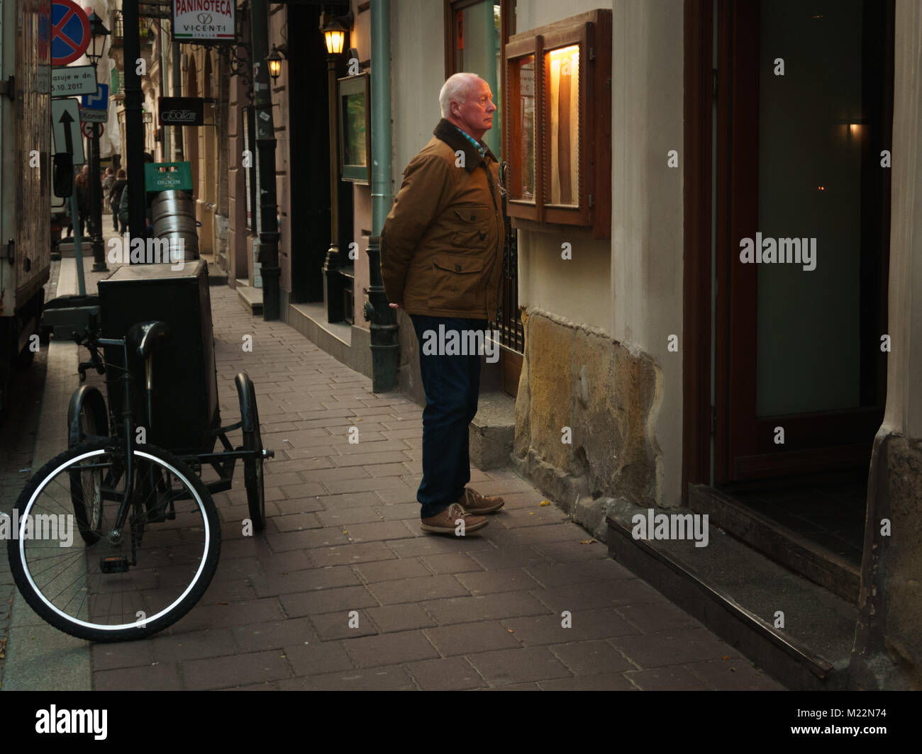 An old man checking a restaurant's menu in the evening Stock Photo - Alamy