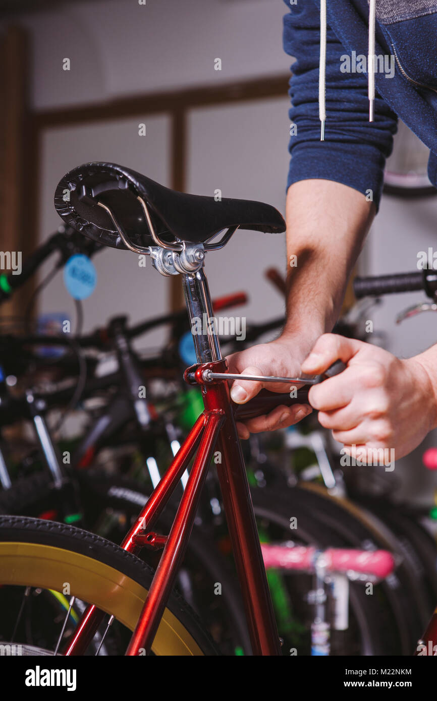 Theme repair bikes. Close-up of a Caucasian man's hand use a hand tool ...