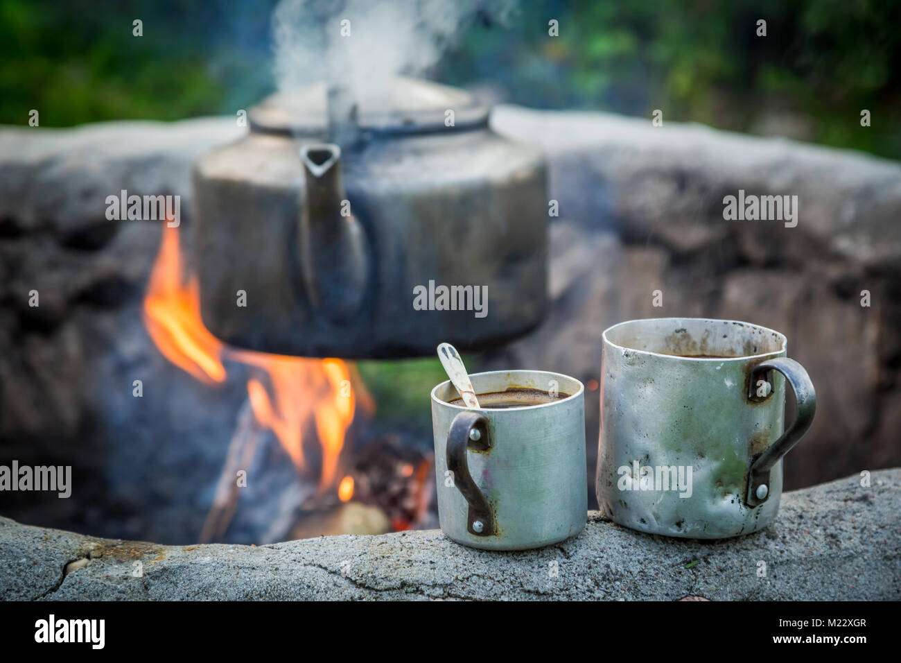 Hot and aromatic coffee with kettle on bonfire Stock Photo - Alamy