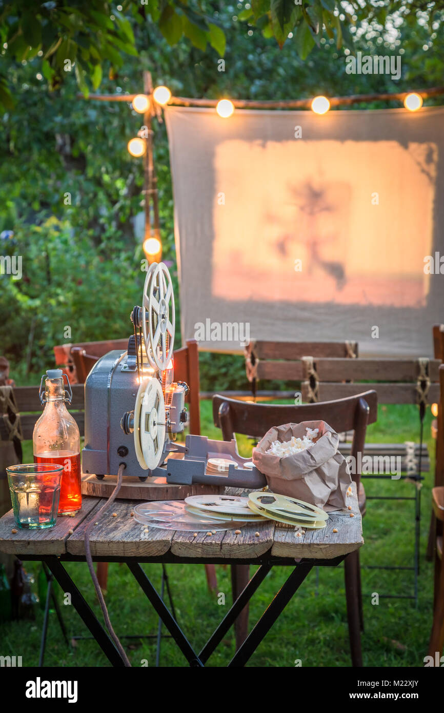 Open-air cinema with retro projector in the garden Stock Photo - Alamy