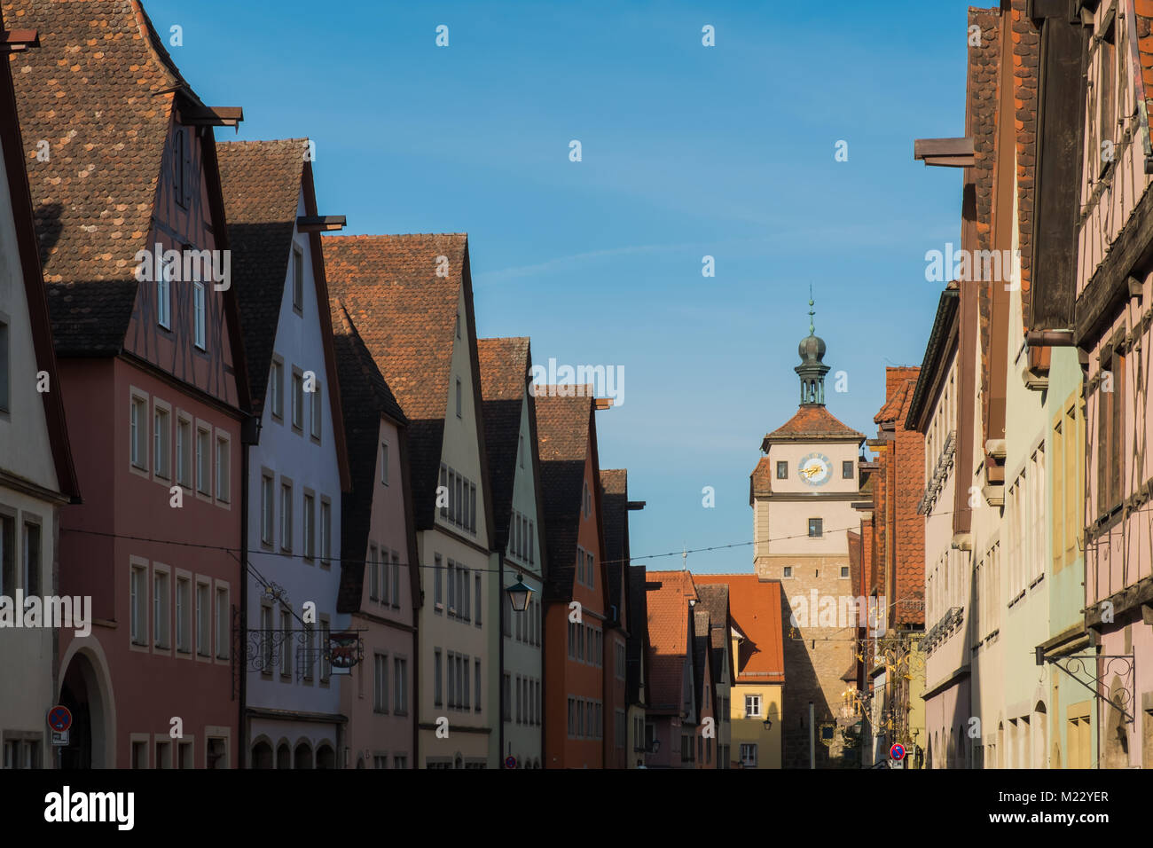 Colorful building and clock tower in old street of Rothenburg ob der ...