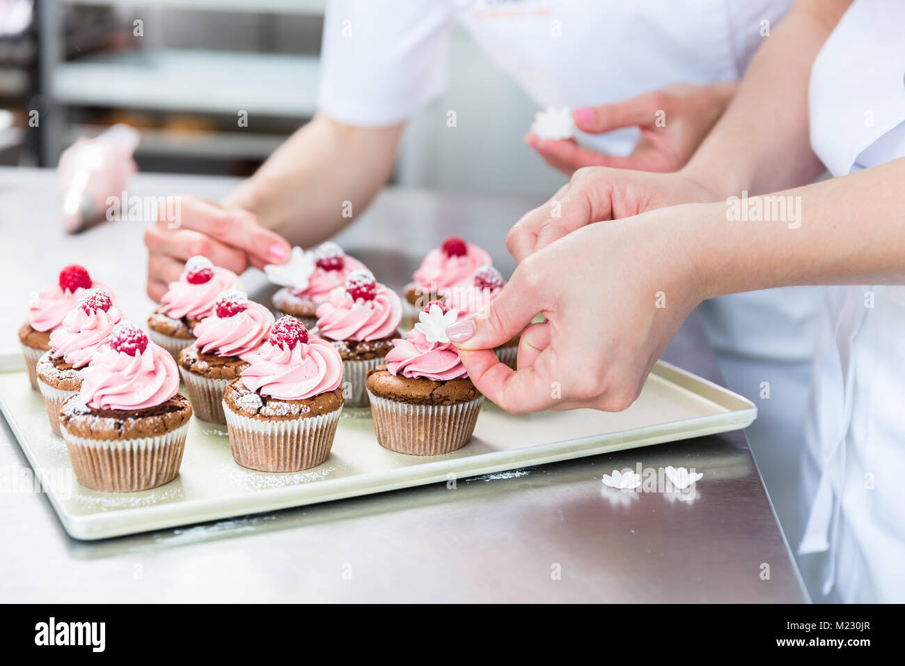 Women in pastry bakery working on muffins Stock Photo - Alamy